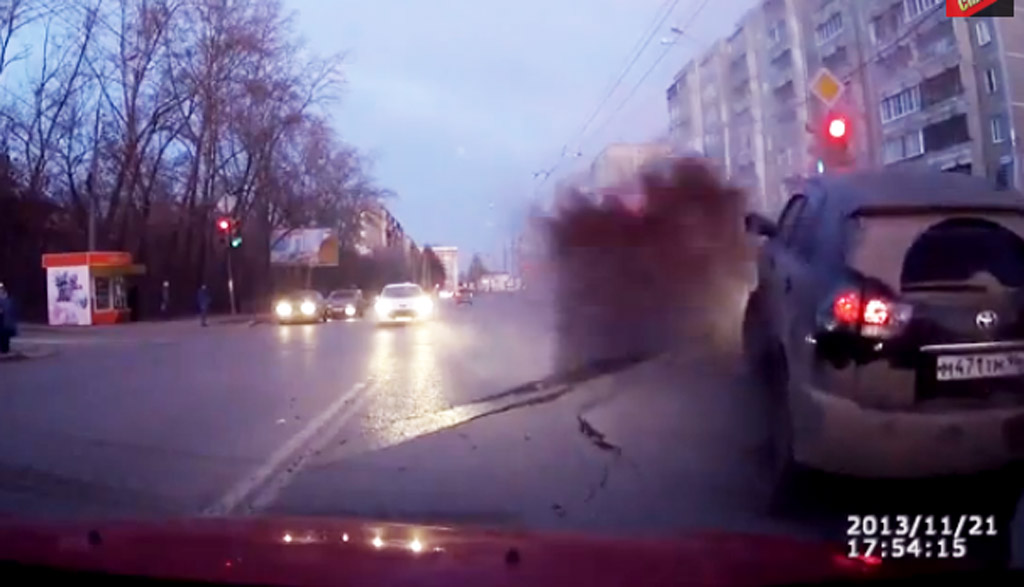 Burst Water Main Causes Road To Explode, Crash Ensues: Video